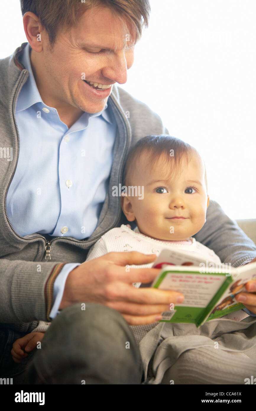 Father Reading Picture Book For Baby Daughter Stock Photo - Alamy