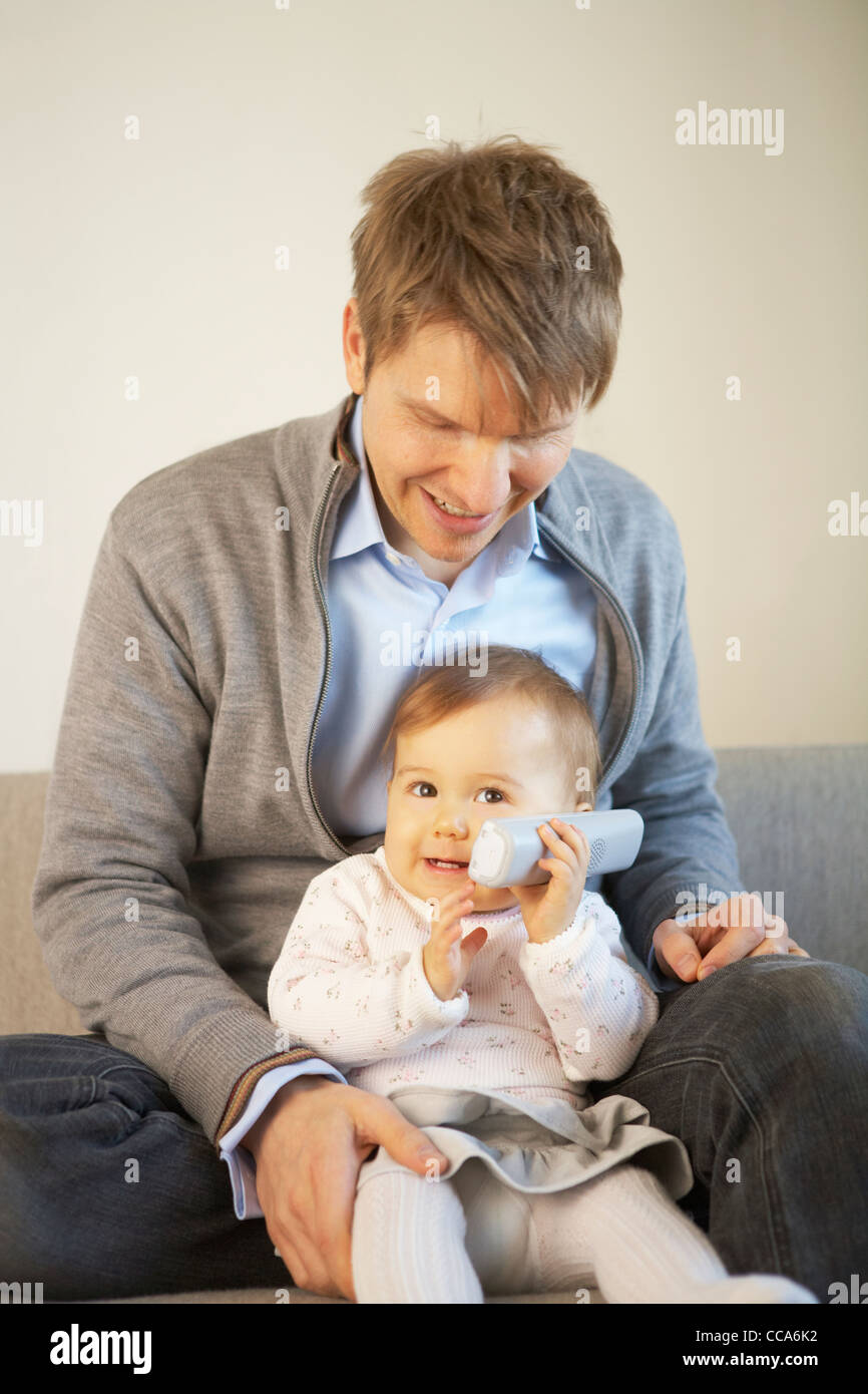 Father Watching Baby Girl Talking on The Phone Stock Photo - Alamy