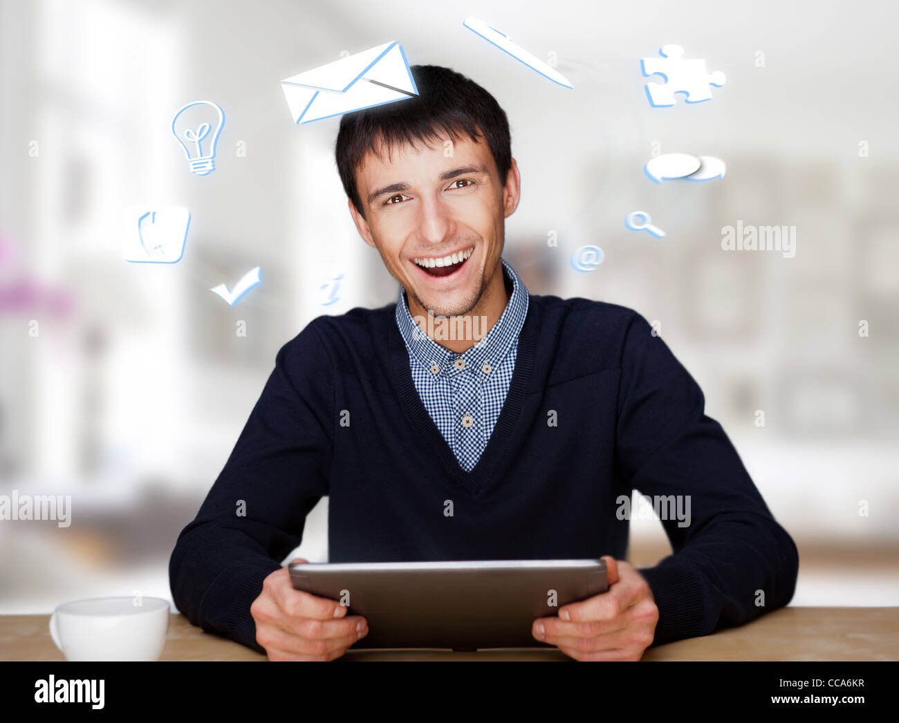 A businessman with icons floating around his head. Portrait of handsome ...