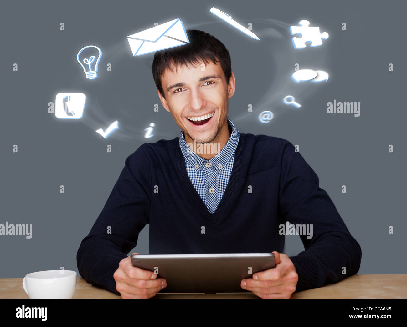 A businessman with icons floating around his head. Portrait of handsome ...