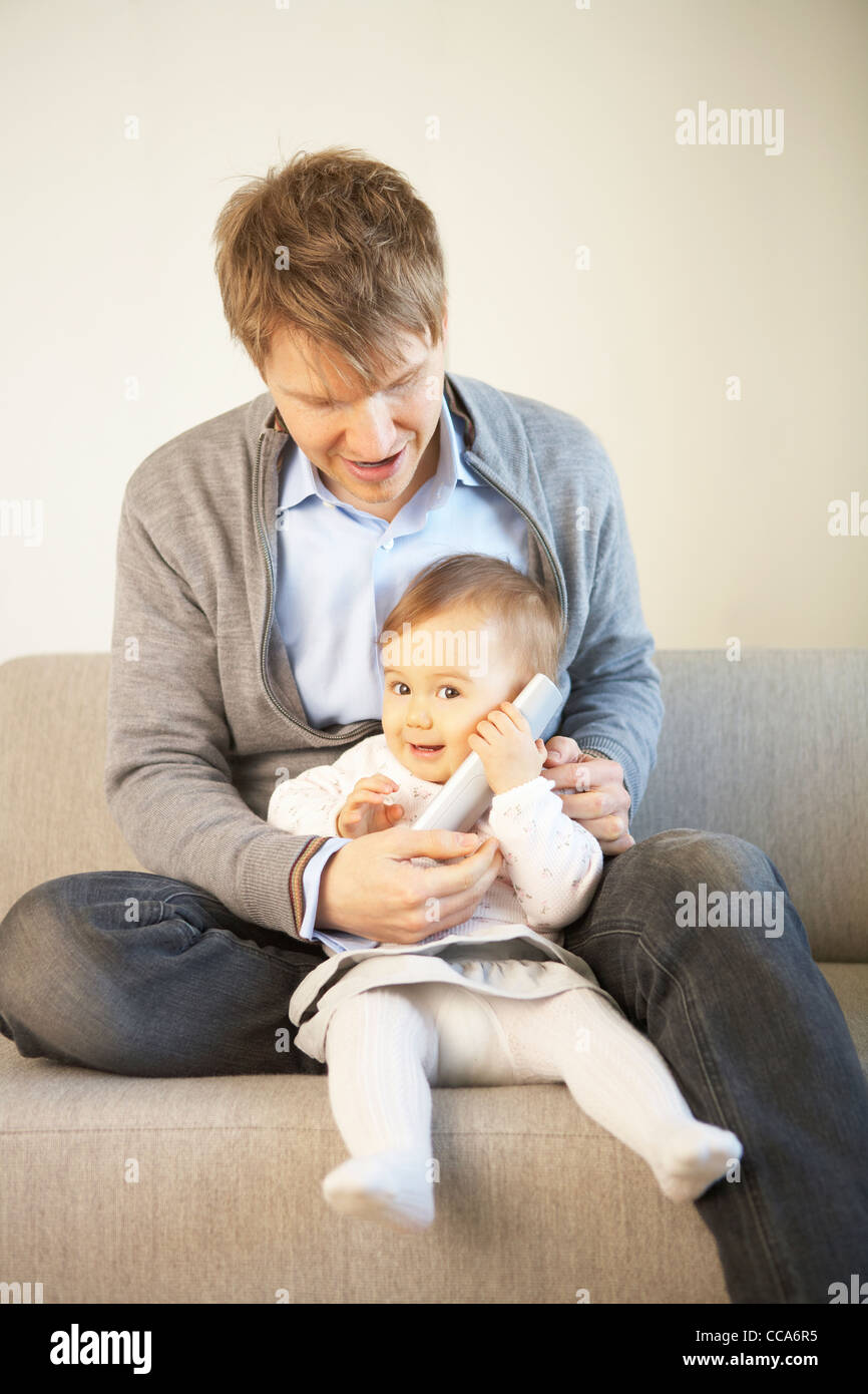 Father Watching Baby Girl Talking on The Phone Stock Photo - Alamy