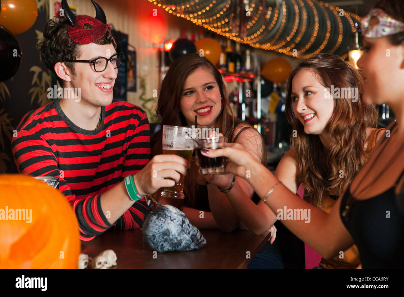 Young friends toasting drinks in bar Stock Photo - Alamy