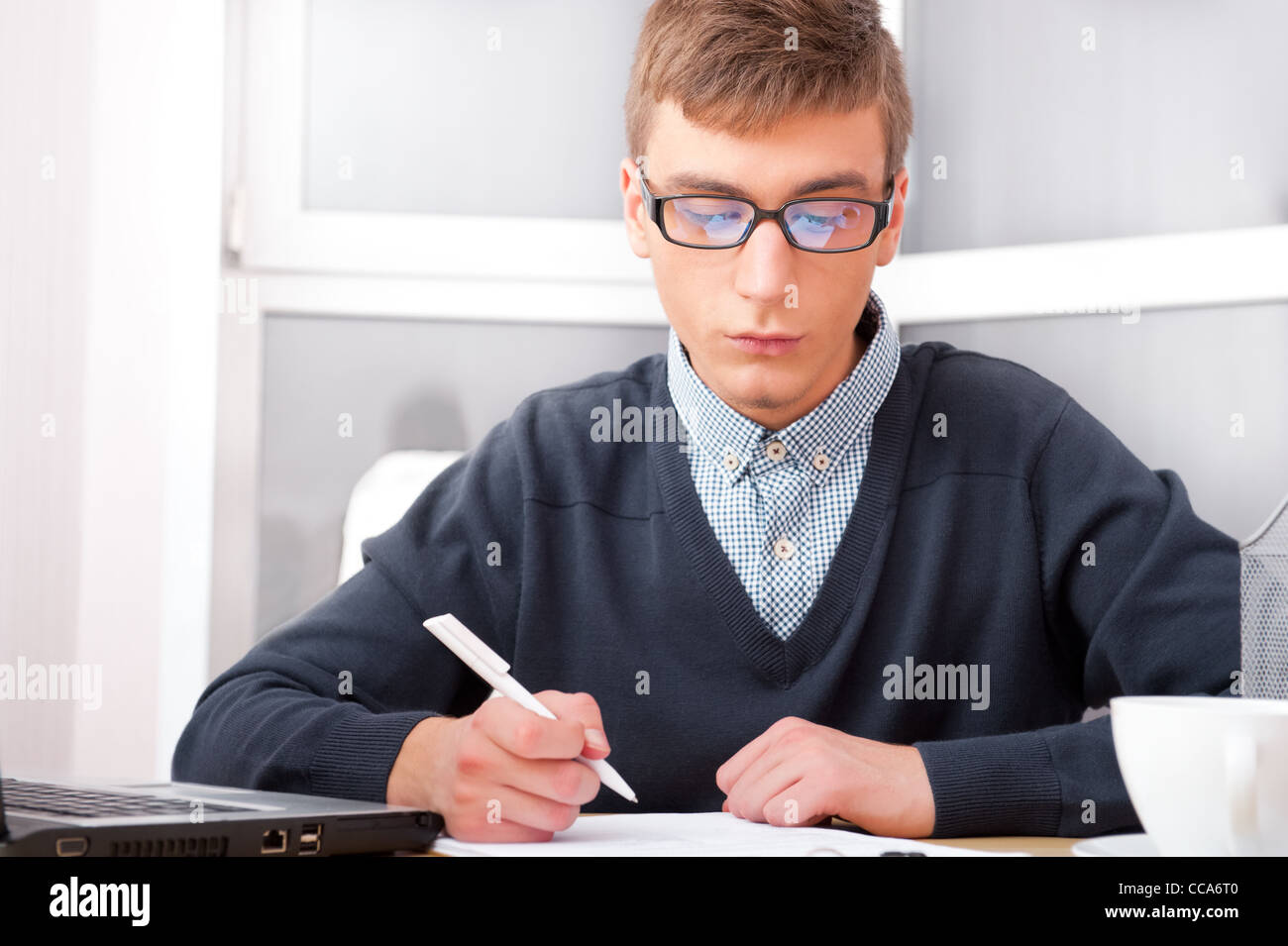 High school - Young male student write notes in classroom Stock Photo ...