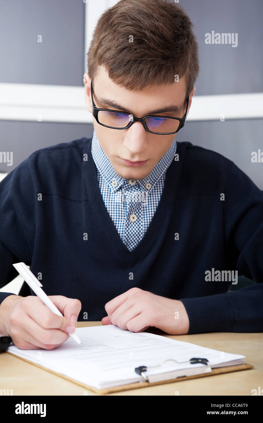 High school - Young male student write notes in classroom Stock Photo ...