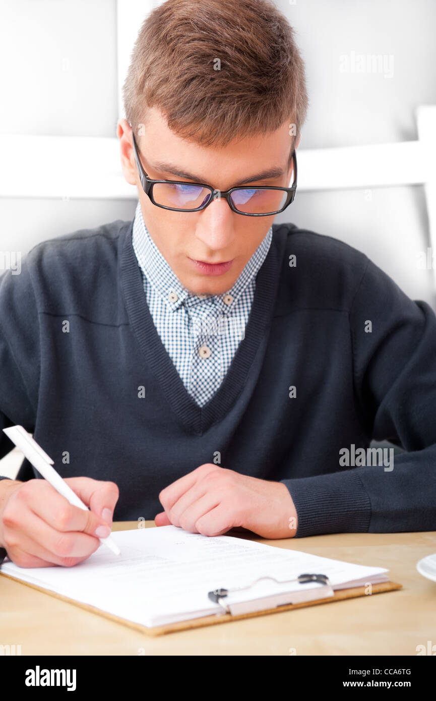 High school - Young male student write notes in classroom Stock Photo ...