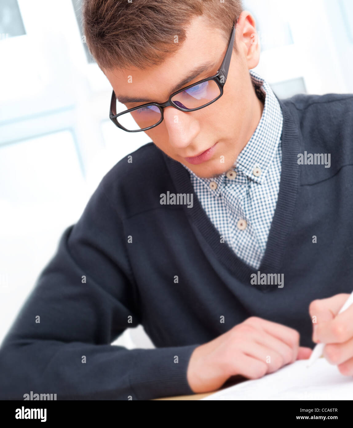 High school - Young male student write notes in classroom Stock Photo ...