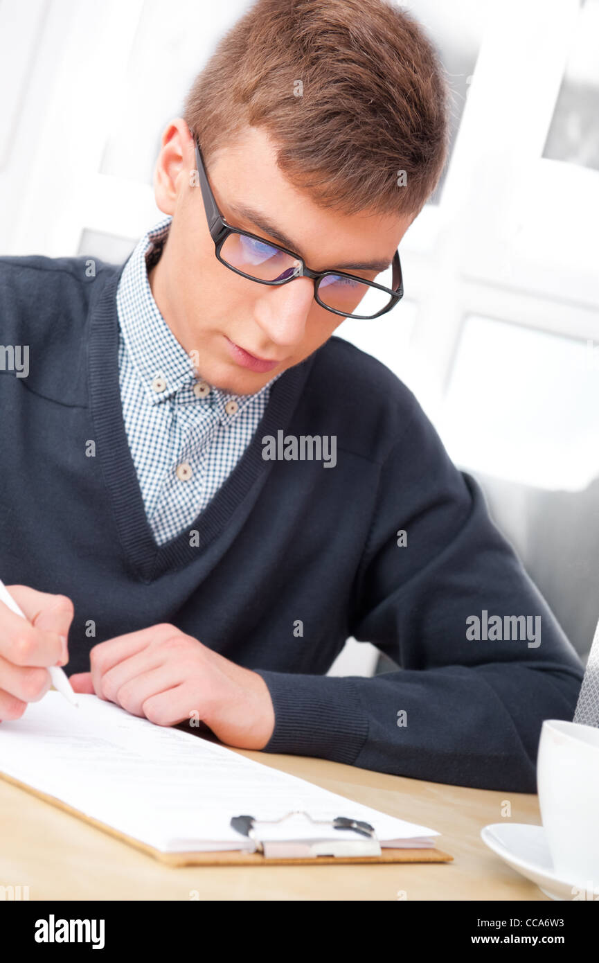 High school - Young male student write notes in classroom Stock Photo ...
