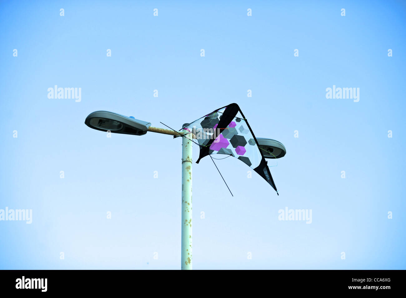 Broken kite left stranded at the top of a lampost Brighton seafront ...