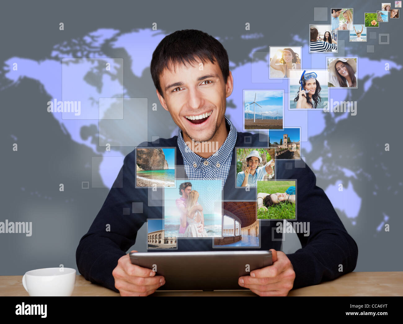 A technology man has images flying away from his modern tablet computer ...