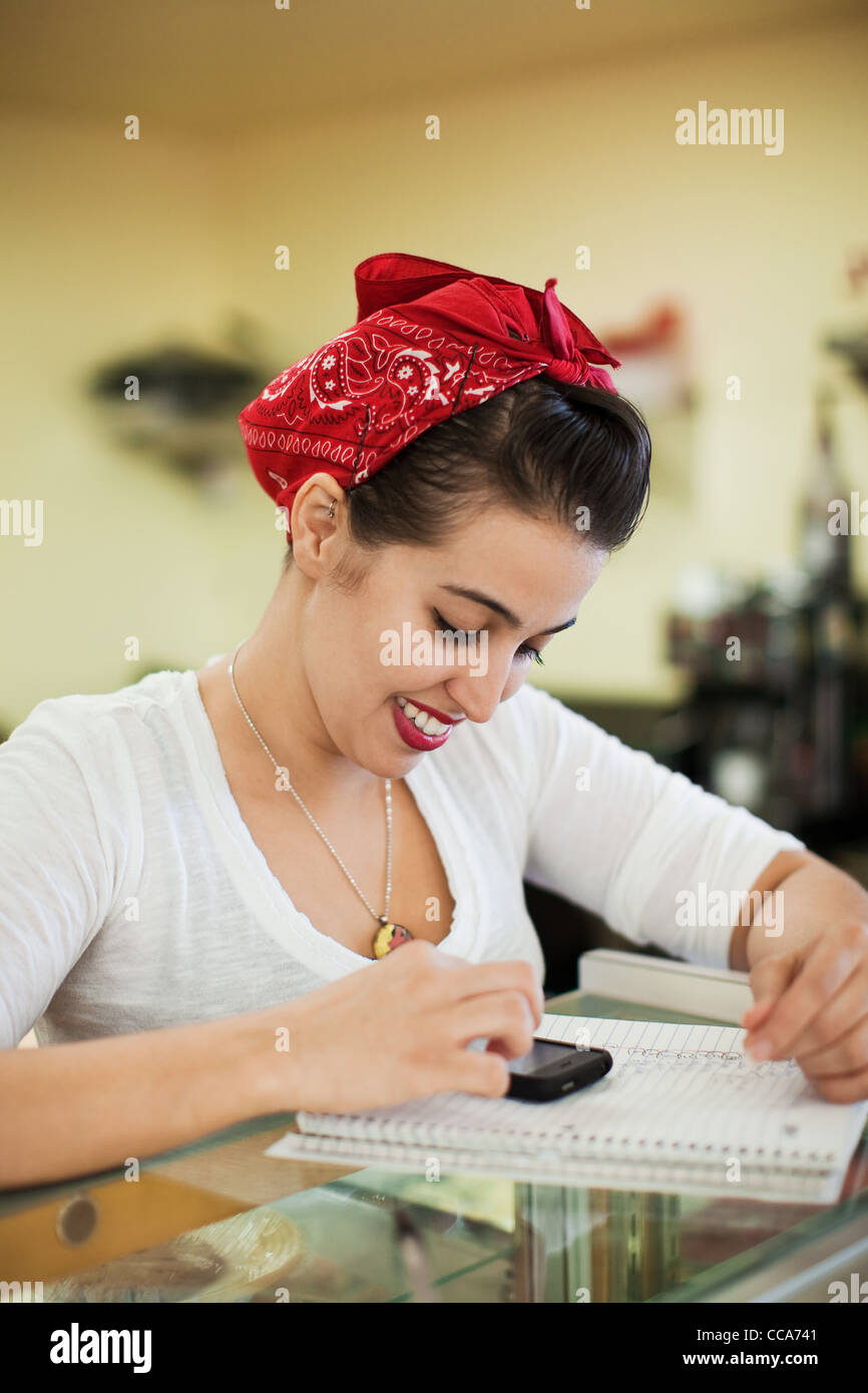 Young woman working on counter of bakery Stock Photo - Alamy