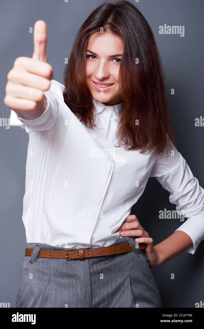 Portrait of a beautiful young business woman standing and thumbs up ... Portrait of a beautiful young business woman standing and thumbs up ...