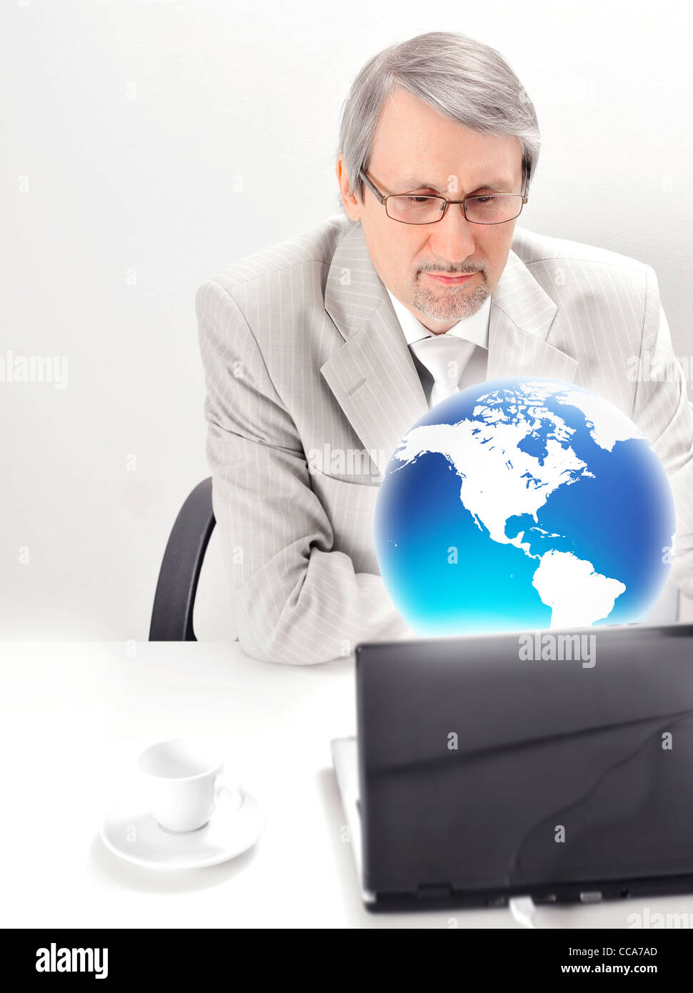 Portrait of an older businessman with a computer and a cup. Isolated ...