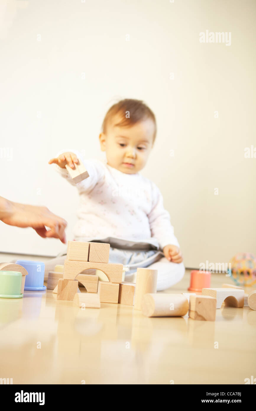 Daughter Playing with Toy Blocks, Mother's Hand Pointing Stock Photo ...