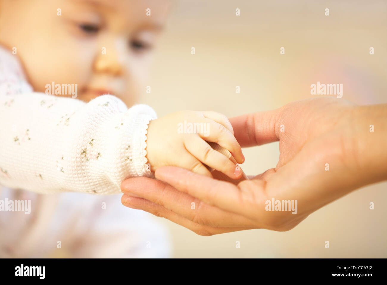 Baby Girl Giving Toy To Mother Stock Photo - Alamy