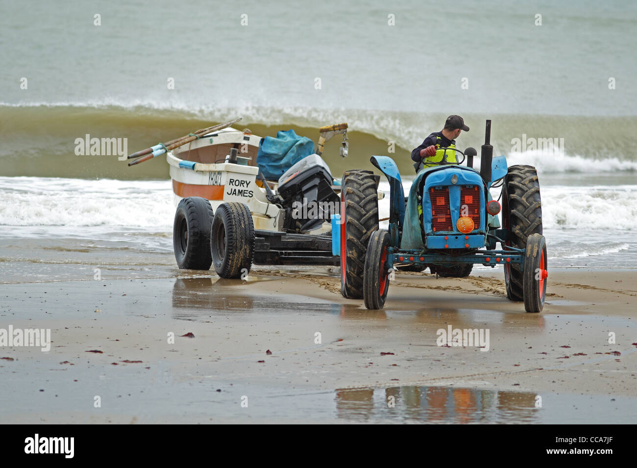 Tractor towing crab fishing boat Stock Photo - Alamy