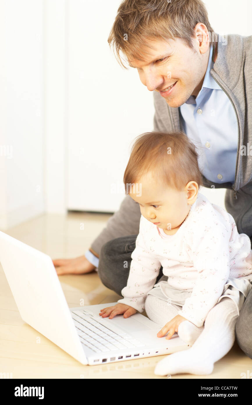 Father and Baby Girl Using Laptop Stock Photo - Alamy