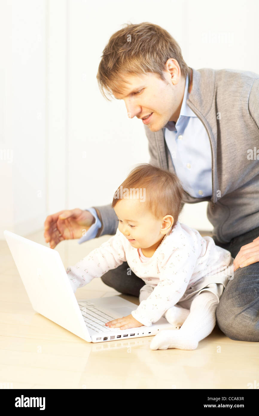 Father and Baby Girl Using Laptop Stock Photo - Alamy
