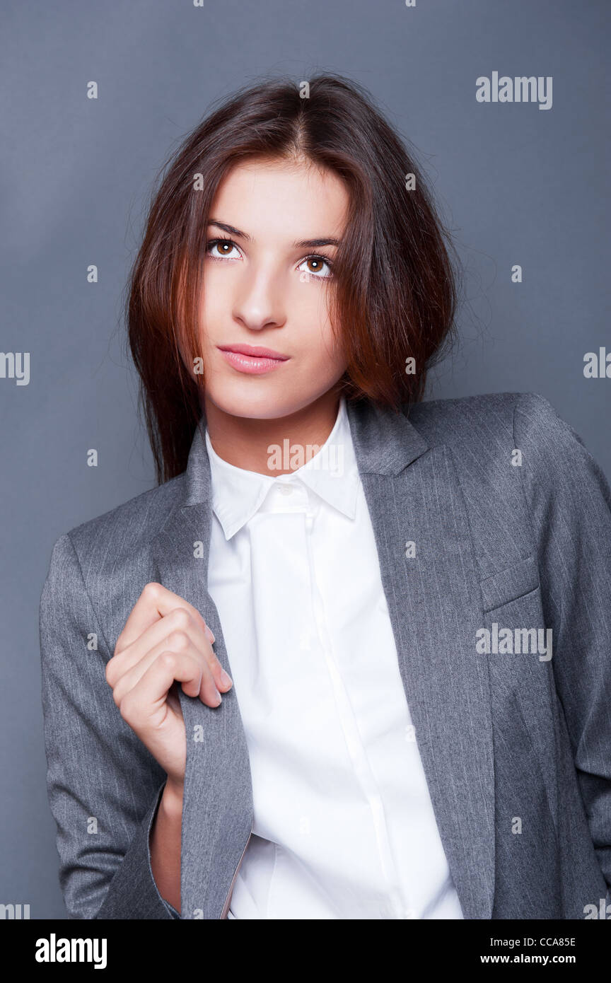 Portrait of a beautiful young business woman standing with hand holding ... Portrait of a beautiful young business woman standing with hand holding ...
