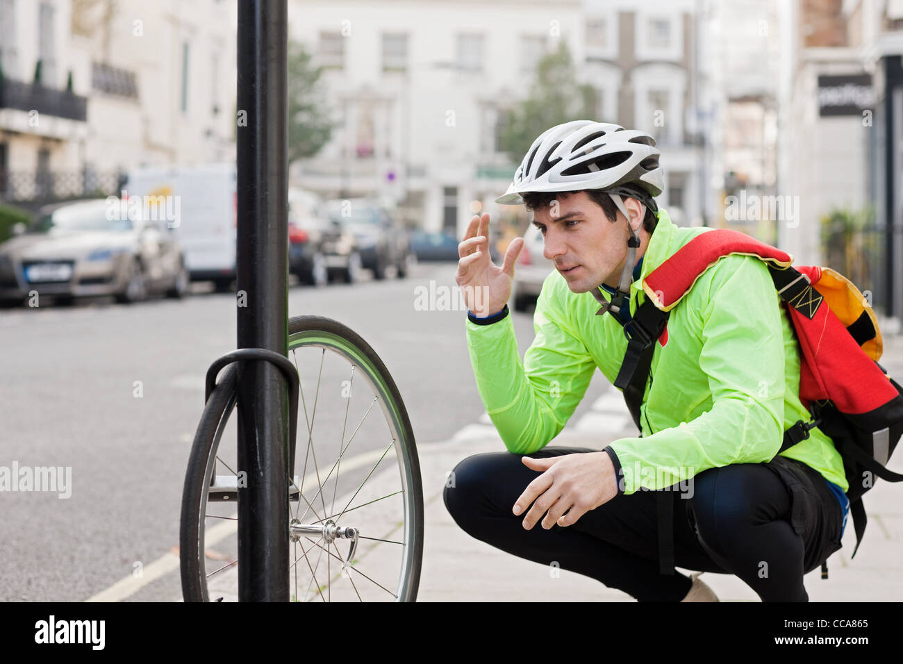 Mid adult man discovering stolen bicycle Stock Photo - Alamy