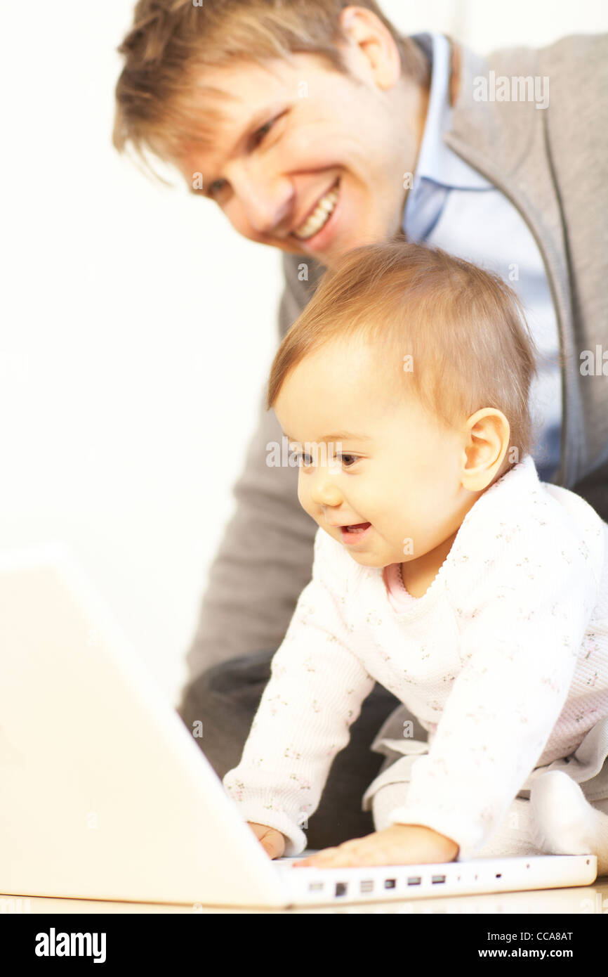 Father and Baby Girl Using Laptop Stock Photo - Alamy