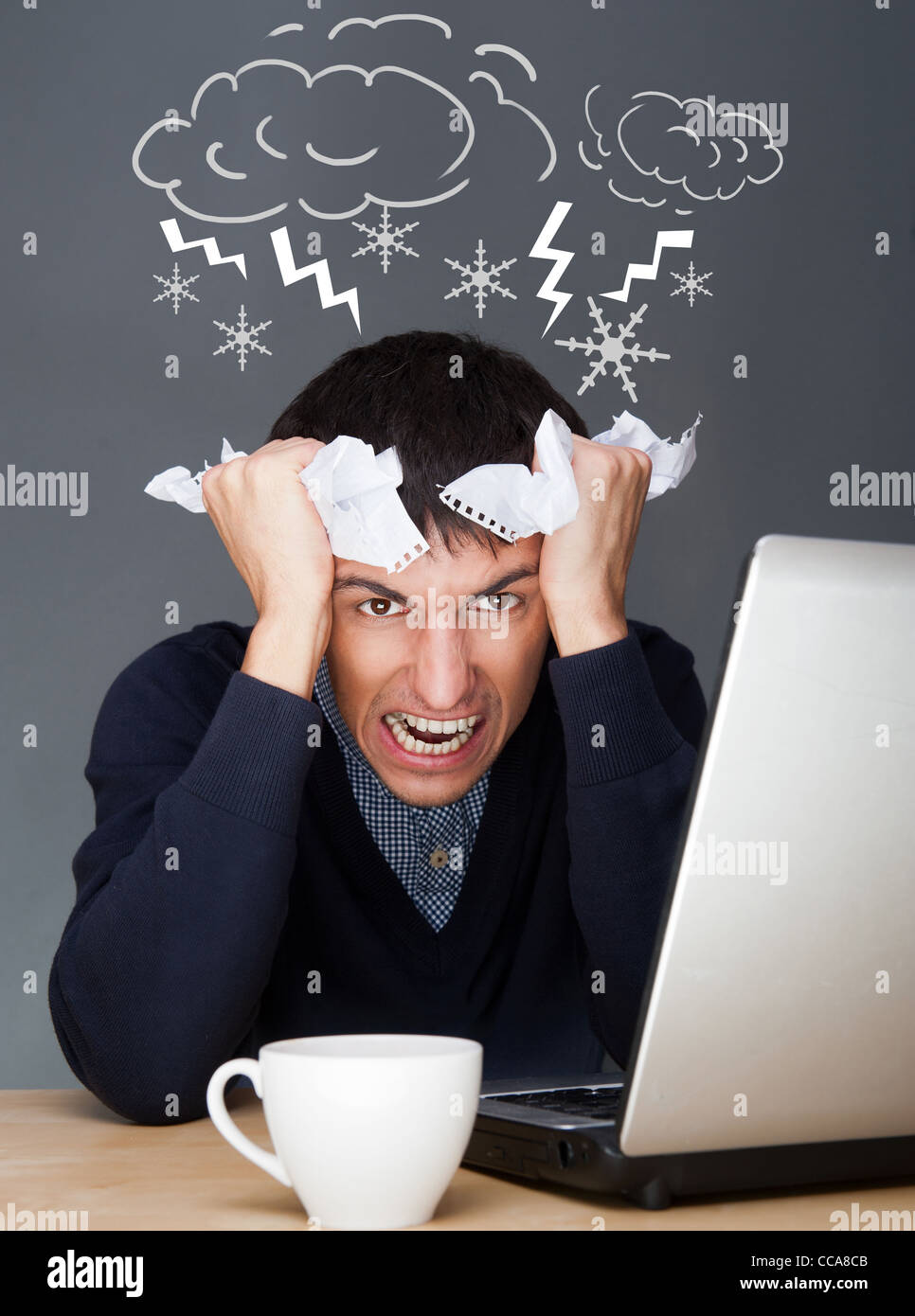 Closeup of a young angry business man having a stress. Headache ...