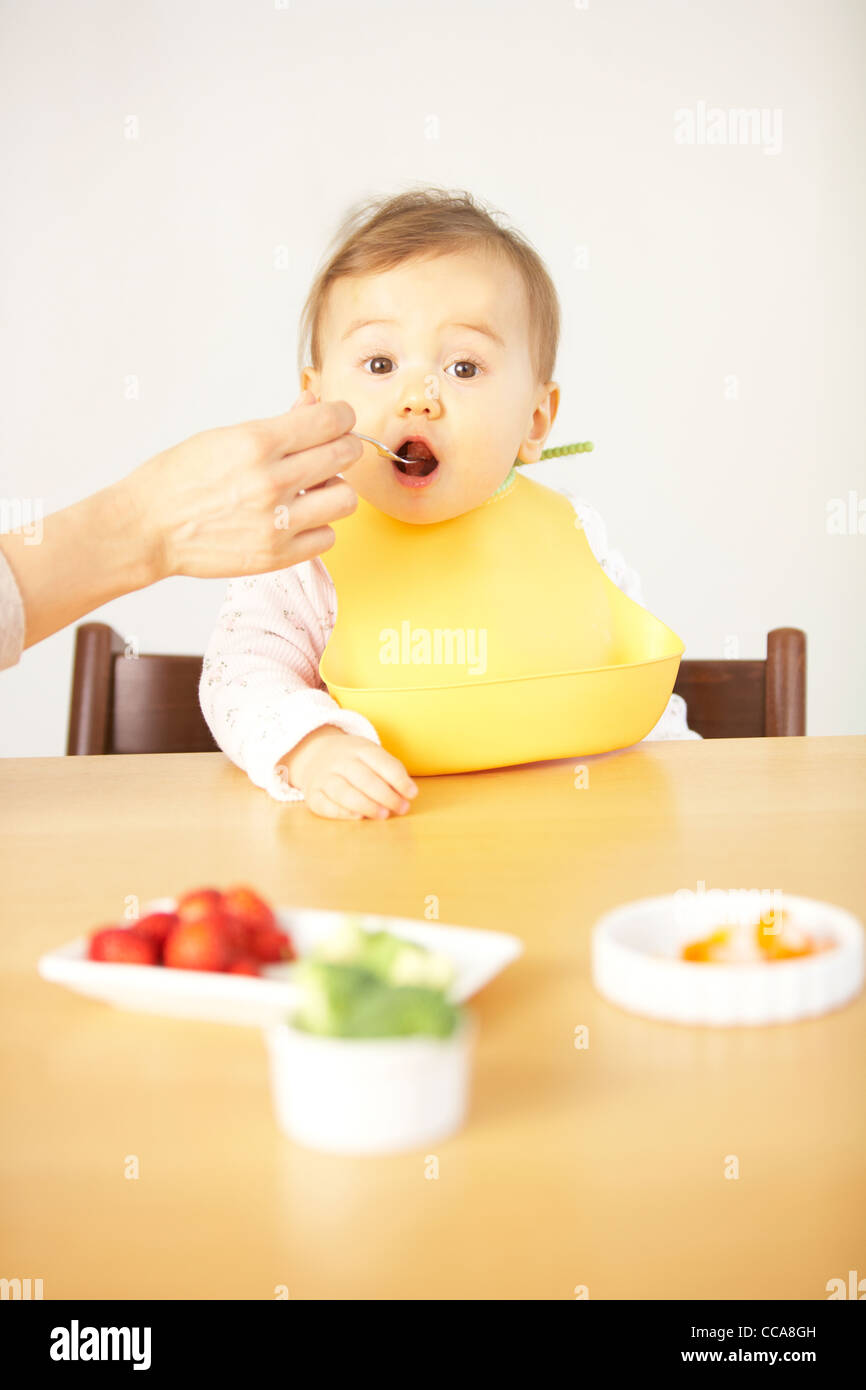 Baby Girl Being Fed Stock Photo - Alamy