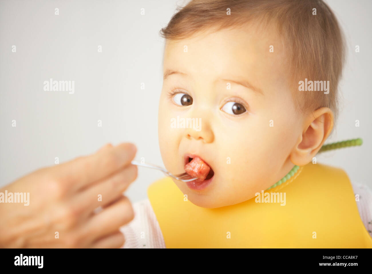 Baby Girl Being Fed Stock Photo - Alamy
