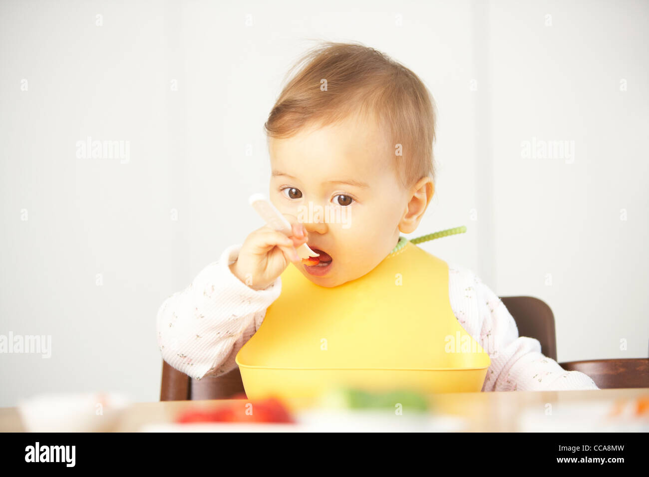 Baby Girl Eating Stock Photo - Alamy