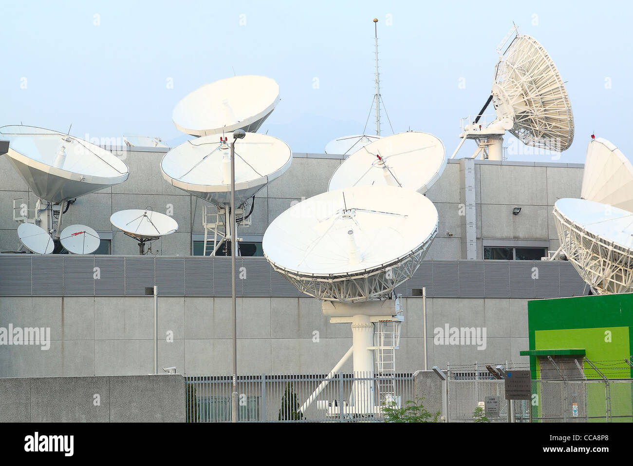 Satellite Communications Dishes on top of TV Station Stock Photo - Alamy