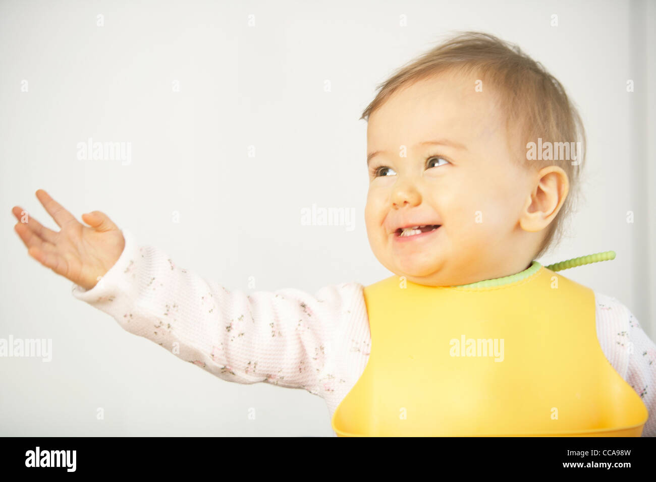 Happy Baby Girl with Hand Raised Stock Photo - Alamy