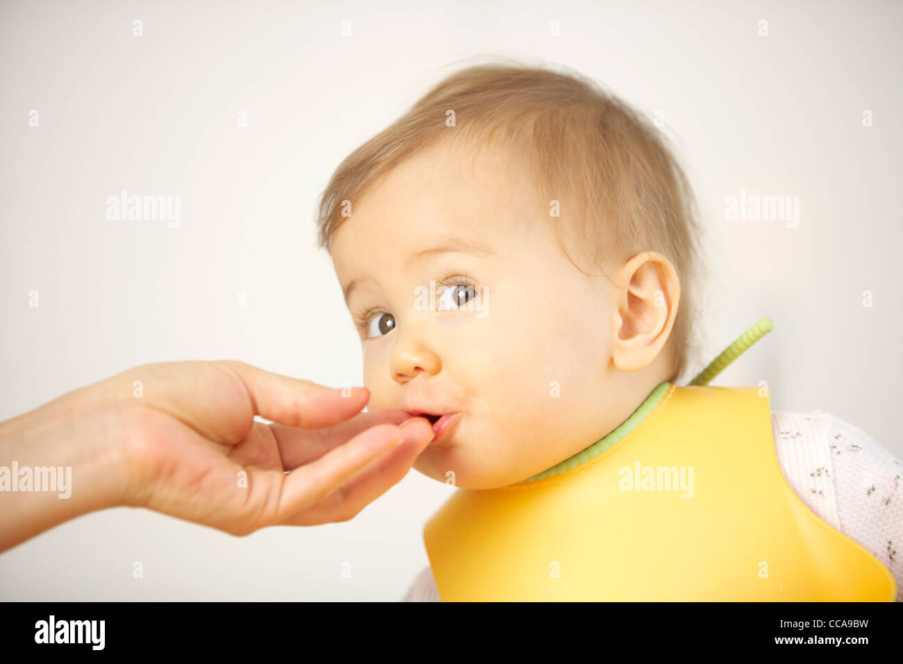 Baby Girl Being Fed Stock Photo - Alamy