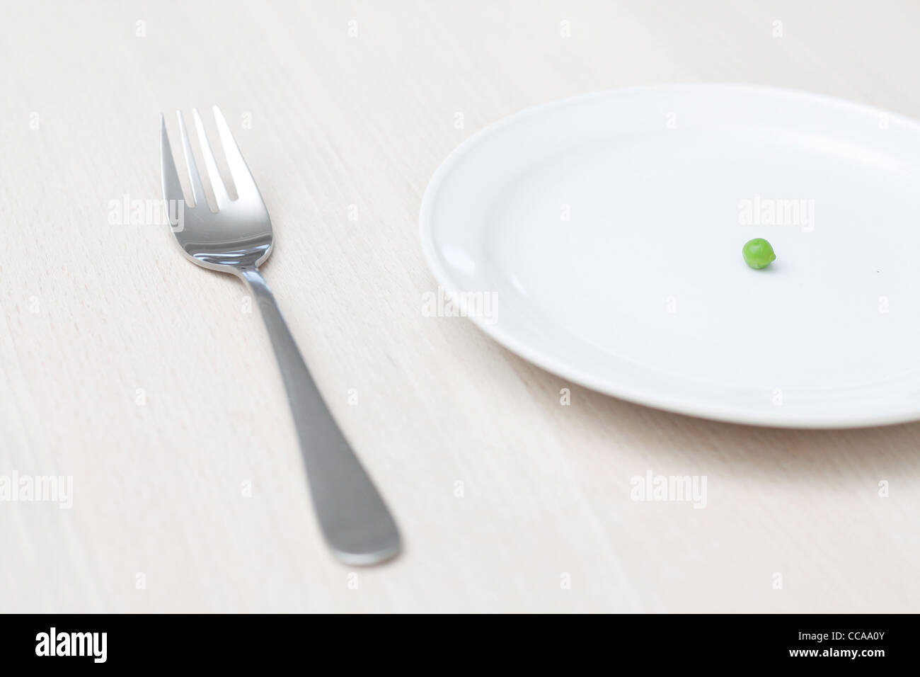 A single pea on a plate Stock Photo - Alamy