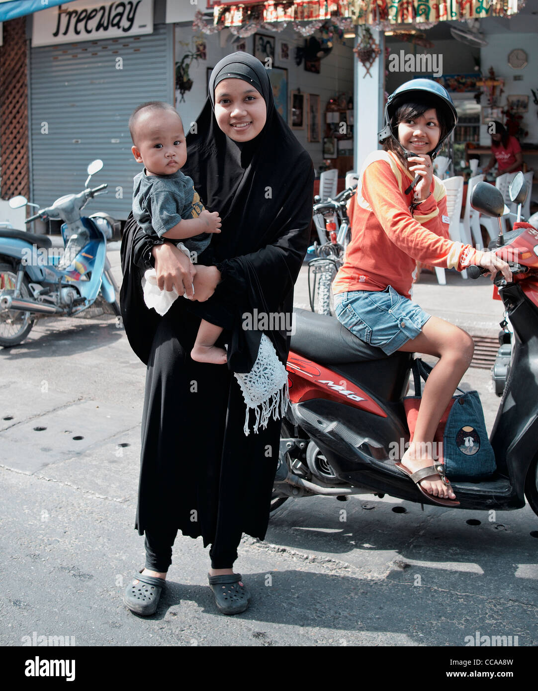 A teenage Muslim mother and her infant child. Thailand S. E. Asia ...