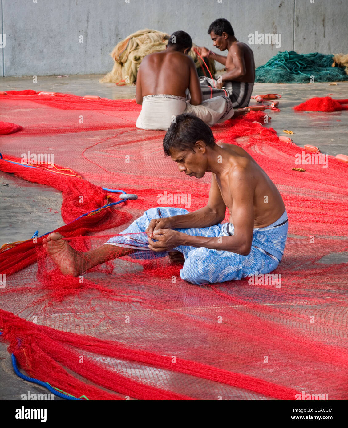 Mending fishing nets Stock Photo - Alamy