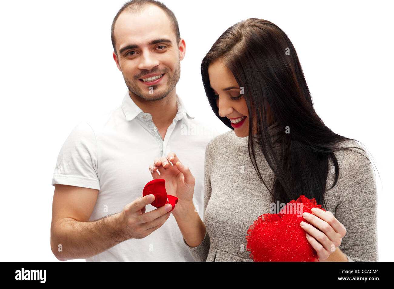 Portrait of handsome young man proposing marriage to a beautiful woman ...