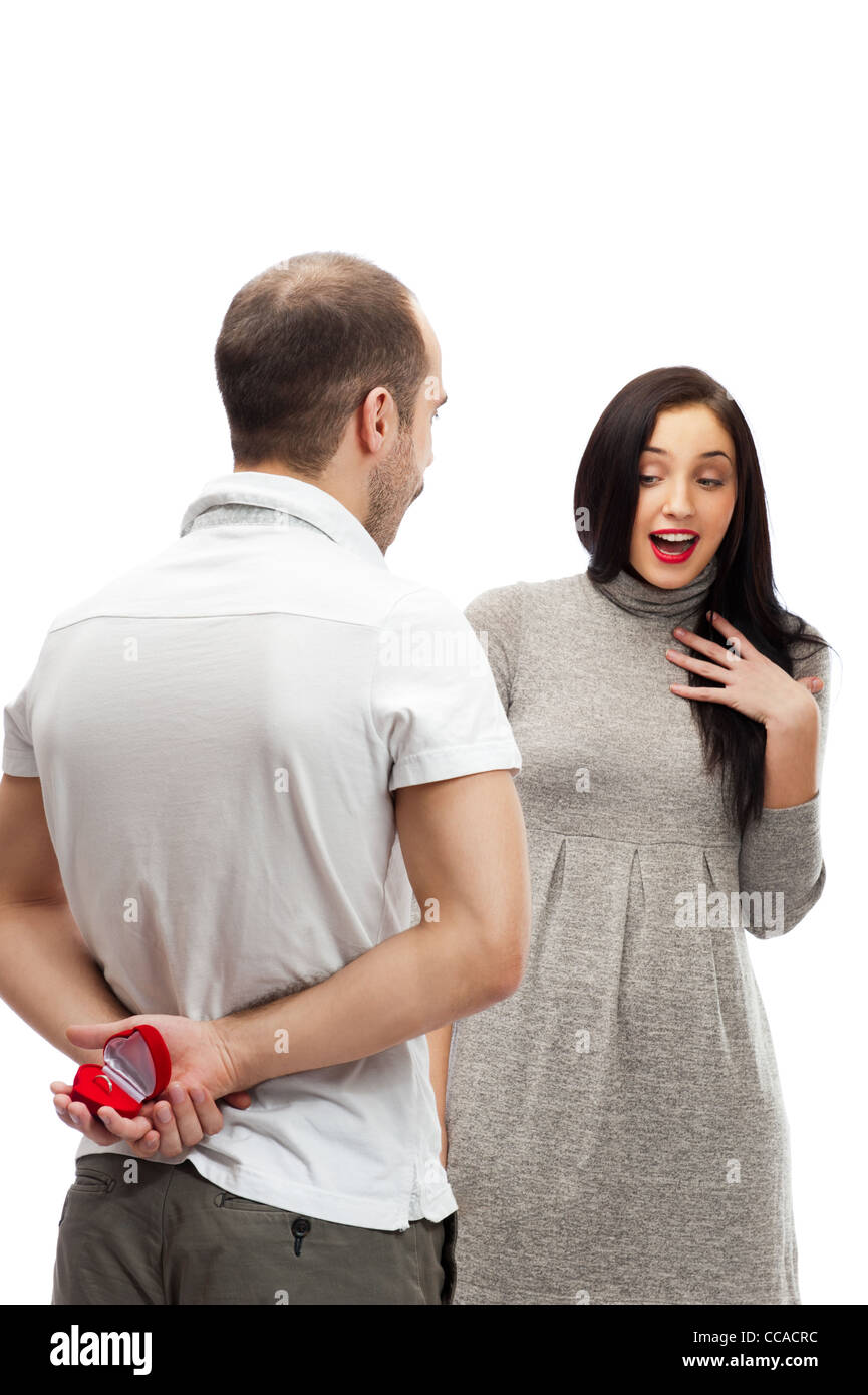 Portrait of handsome young man proposing marriage to a beautiful woman ...