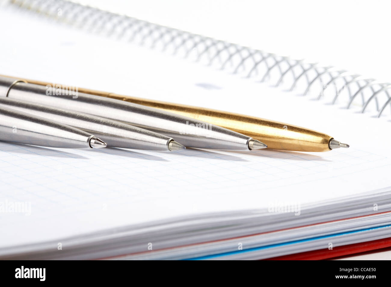 line of ball-point pens lays on a writing-book Stock Photo - Alamy