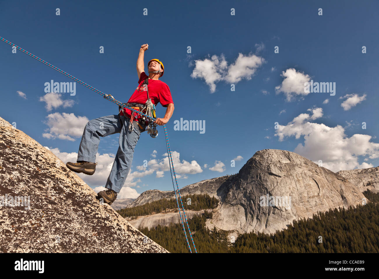 Climber rappelling from the summit after a successful and challenging ...