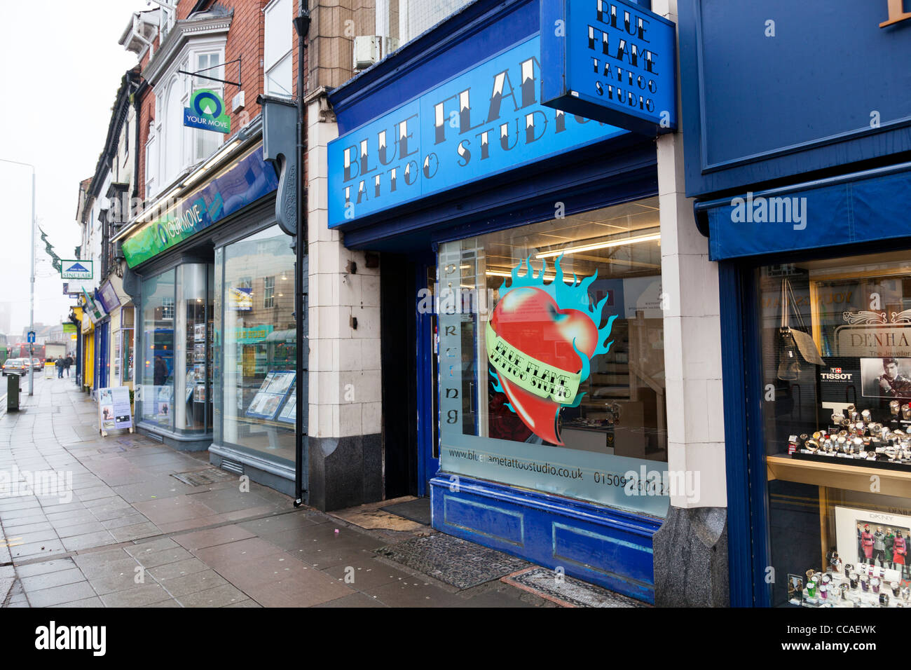 Flamboyant window display in tattoo shop window Stock Photo - Alamy