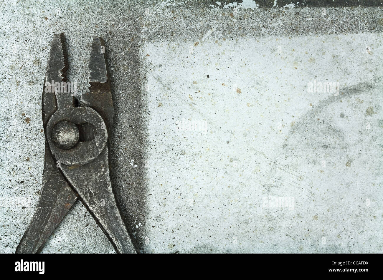 Old rusty pliers on metal background Stock Photo - Alamy