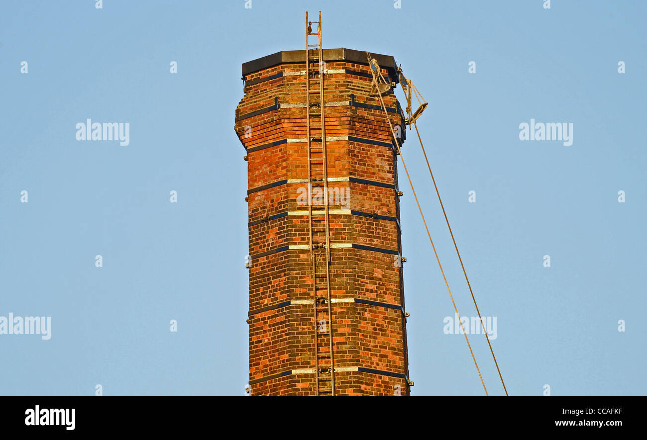 A steeple jacks wooden ladder securely attached to a brick built ...