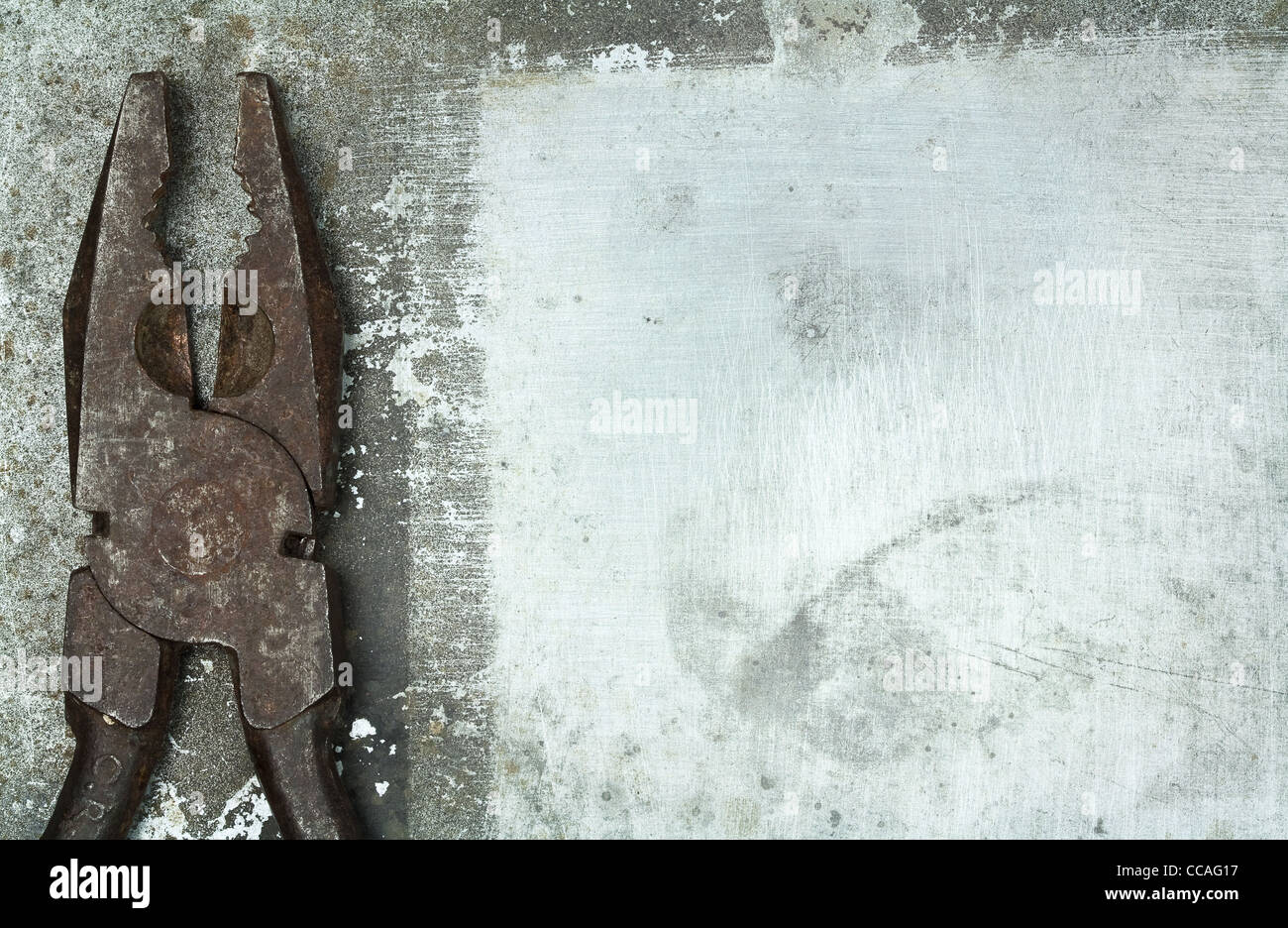 Old rusty pliers on metal background Stock Photo - Alamy