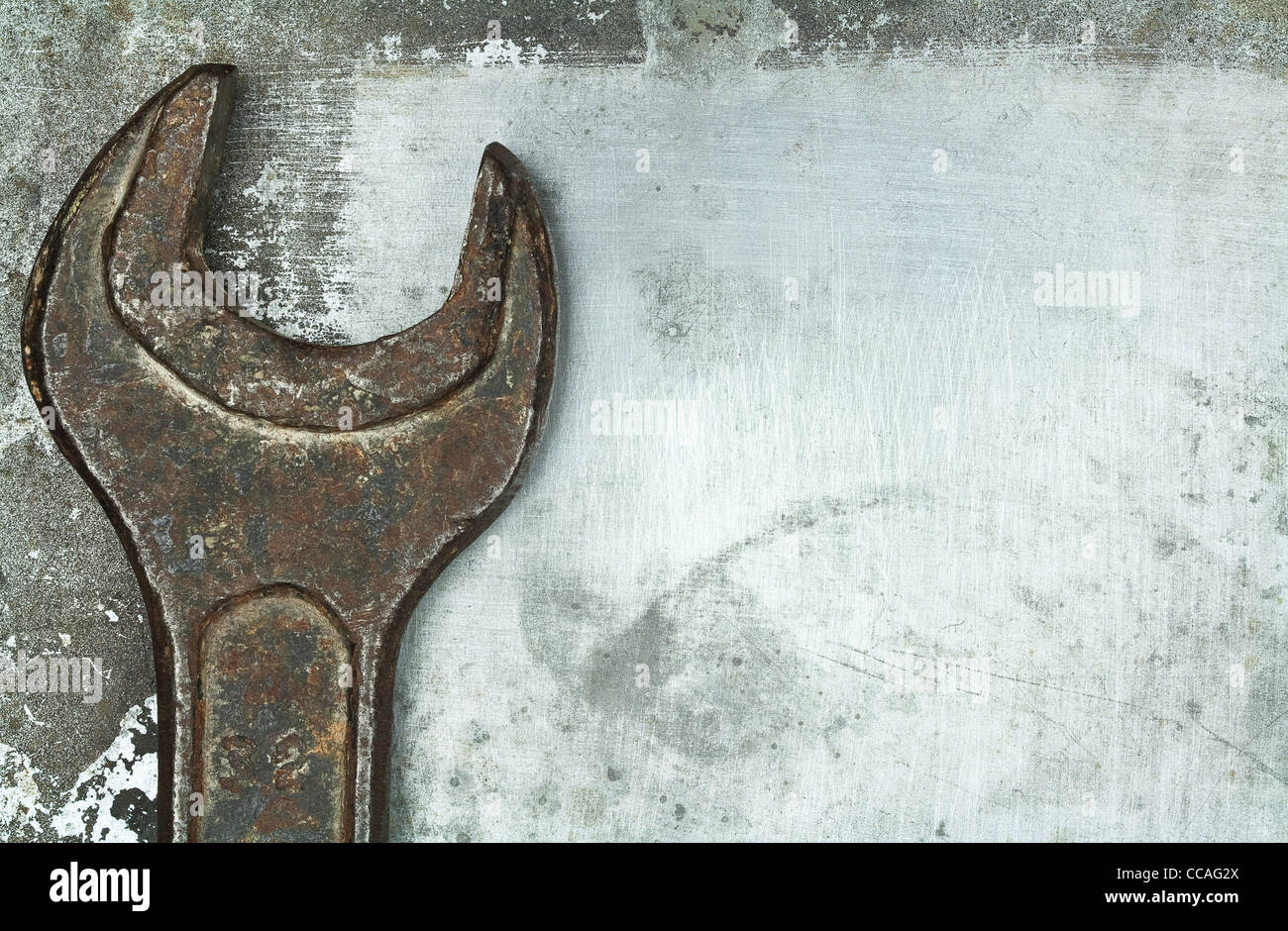 Old rusty wrench on metal background Stock Photo - Alamy