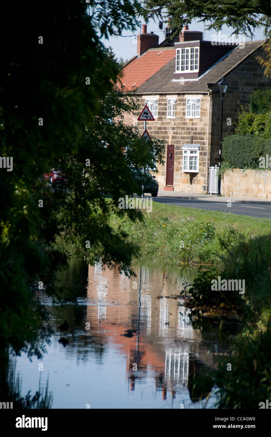 A river reflection of a cottage in Great Ayton, North Yorkshire ...