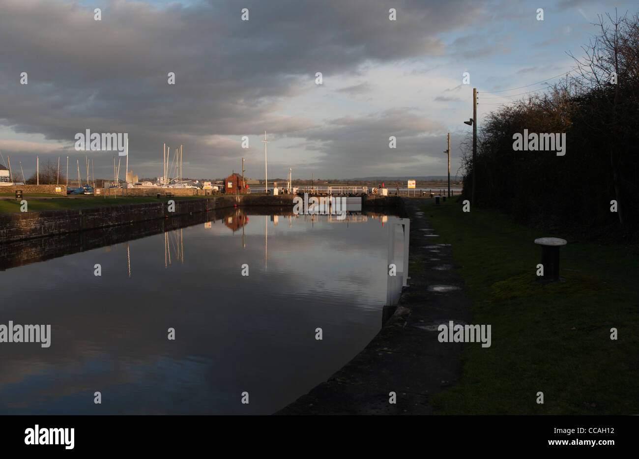 Lydney Harbour with canal and lock gates late afternoon sun and calm ...