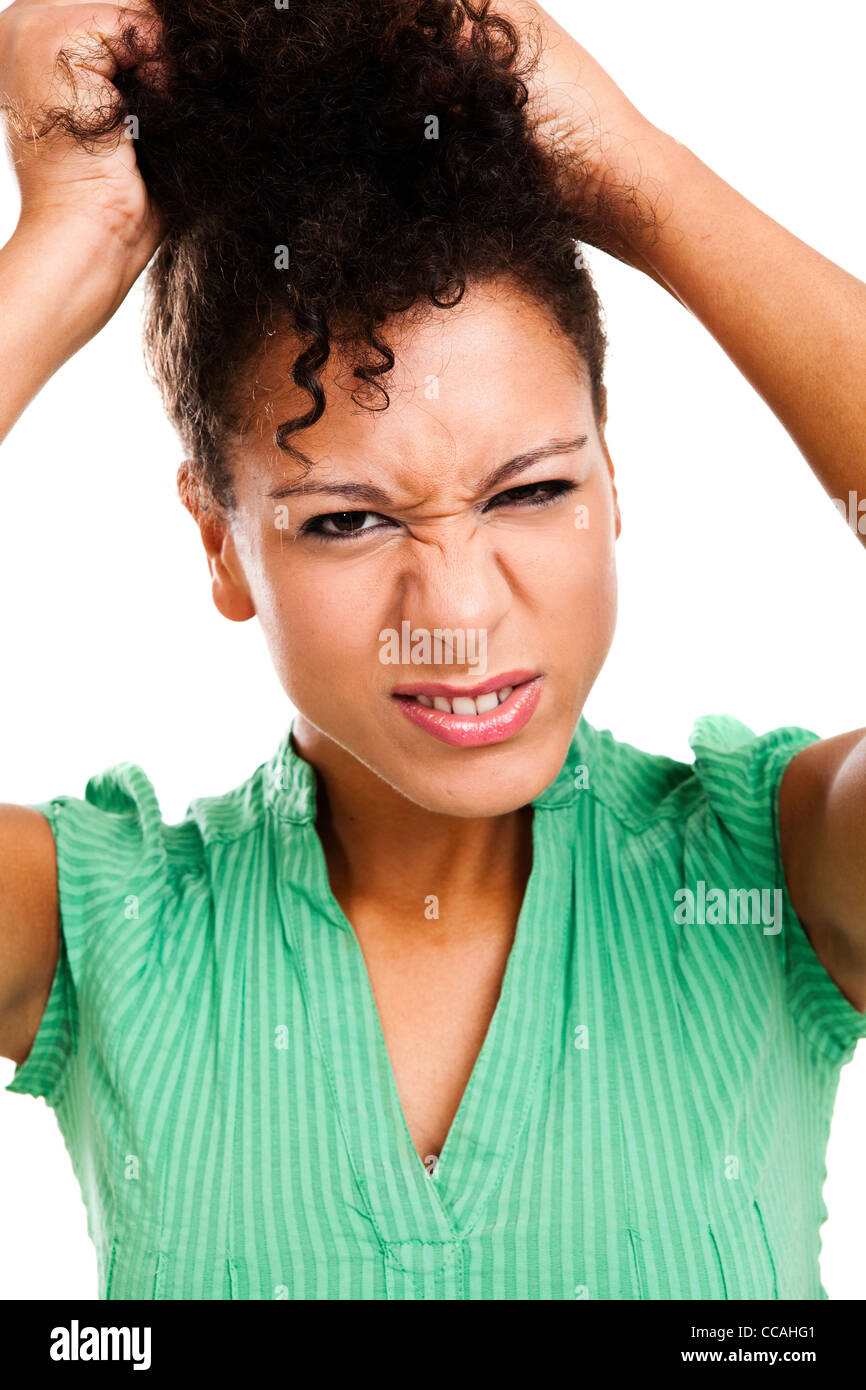Woman pulling hair in frustration. Studio shot with isolated white ...