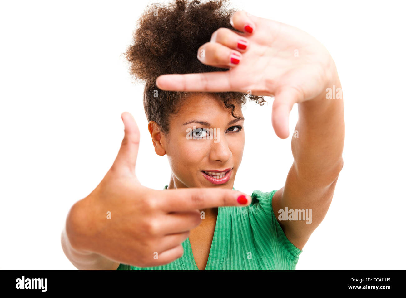 Portrait of a beautiful woman creating a frame with her fingers. Studio ...