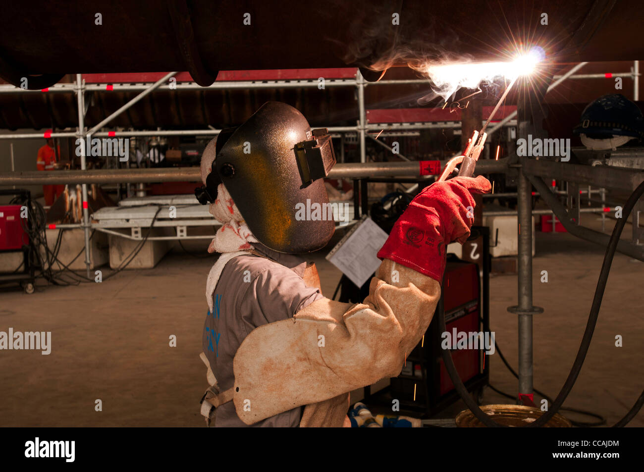 A welder during welding activities in a workshop Stock Photo - Alamy