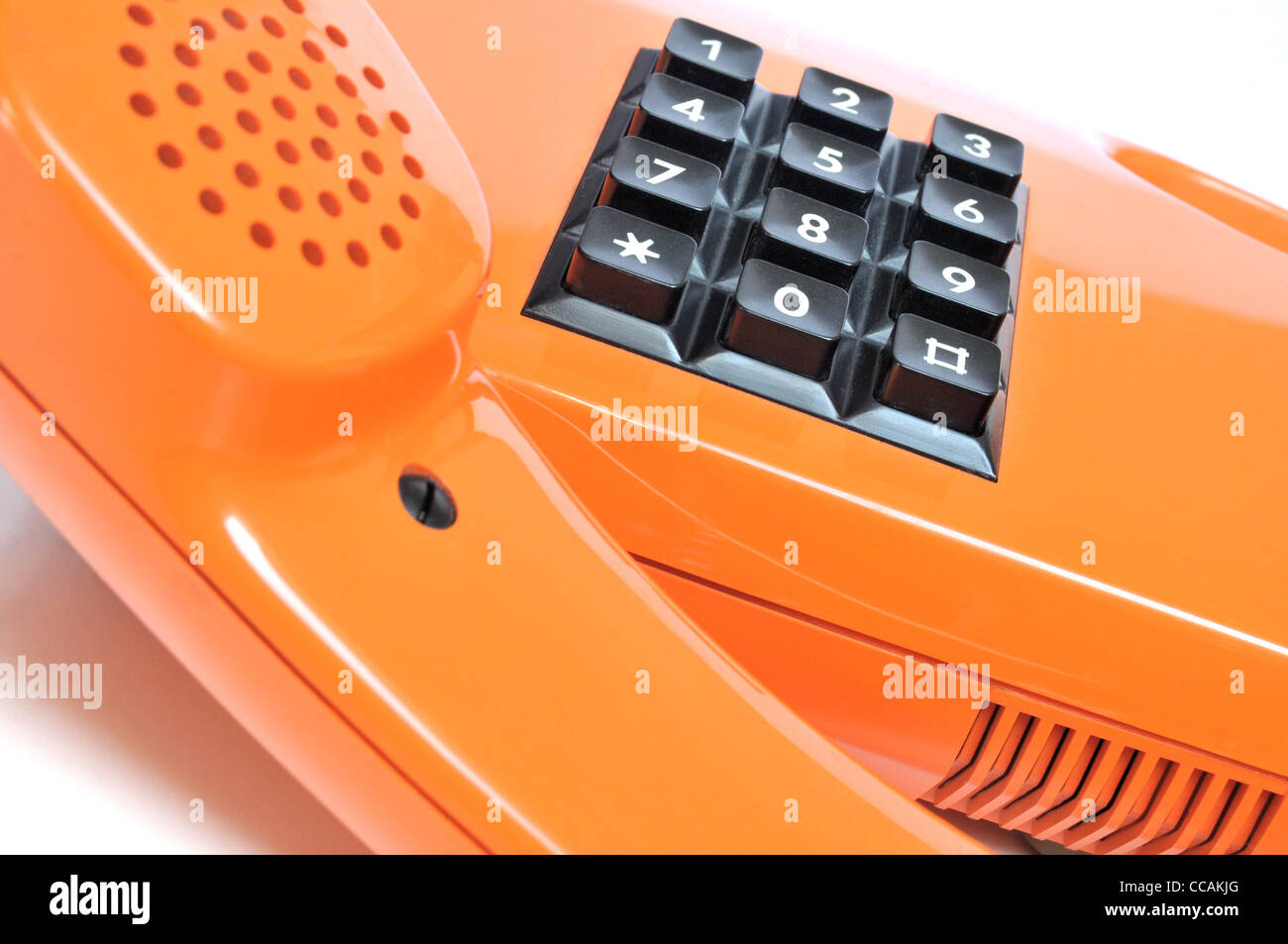 Orange colored retro telephone on white background Stock Photo - Alamy