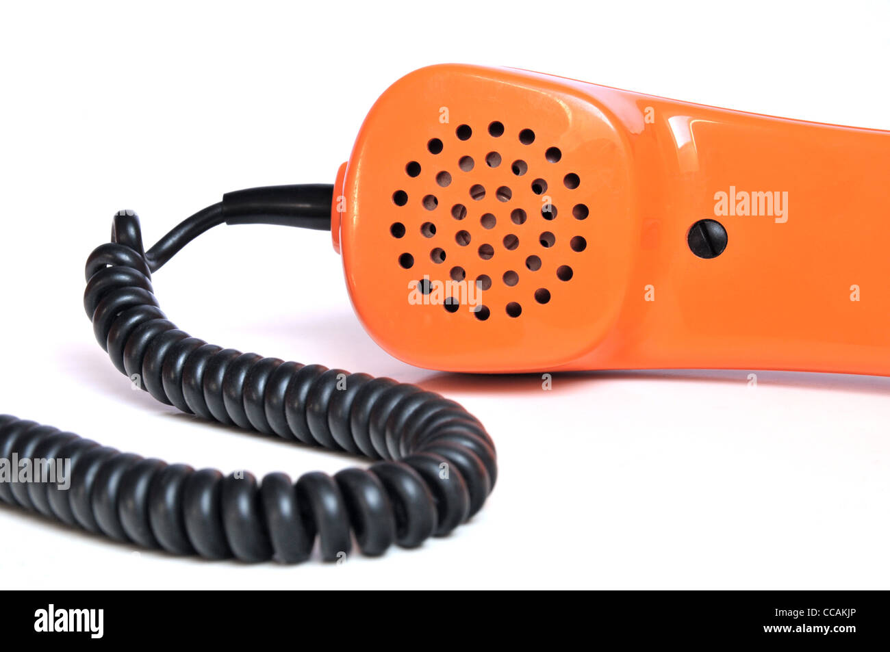 Orange colored retro telephone on white background Stock Photo - Alamy